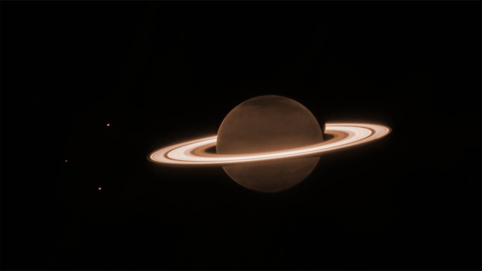 Saturn's rings glow in latest JWST image | Popular Science